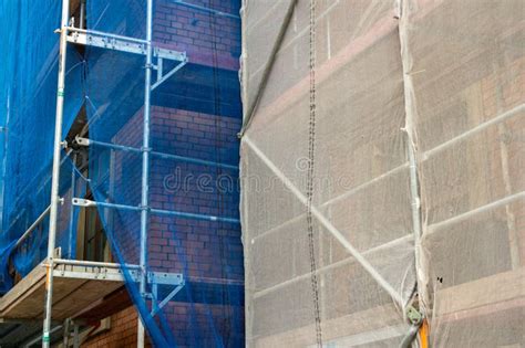 Scaffolding With Safety Net On A Construction Site On A House Stock