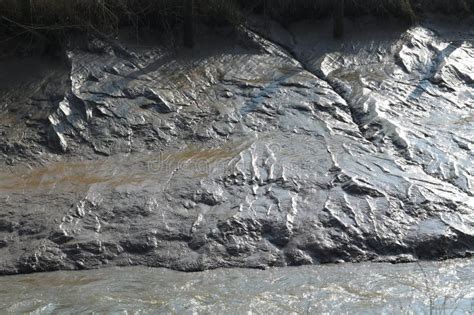 Full Frame Image Of Mud Flat With Small River In Foreground Stock Image