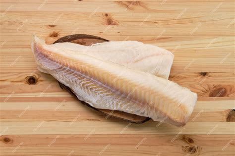 Premium Photo Frozen Fillet Of Cod On Wooden Table