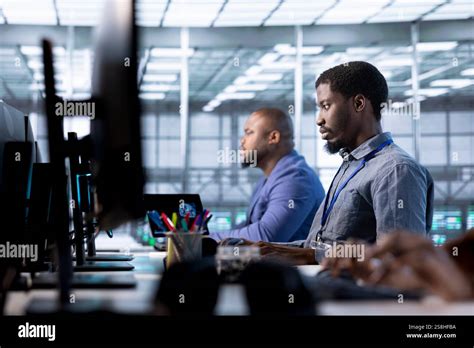 Team Of Admins In Data Center Using Diagnostic Tools And System Monitoring Software On Computers