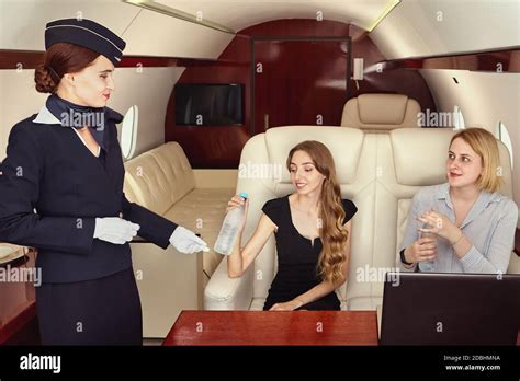 Cabin Crew Serves Business Class Passengers Inside The Plane Air Hostess Is Serving Female