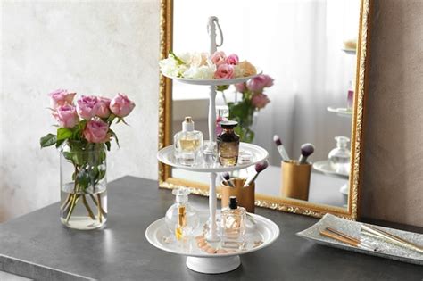 Premium Photo | Stand with bottles of perfume on table