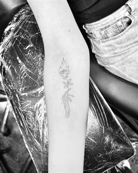 Skeleton Hand Holding Rose Tattoo