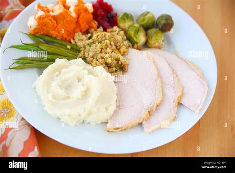 Plate Of Roast Turkey Slices Mashed Potatoes Stuffing Brussels Sprouts Mashed Sweet Potatoes