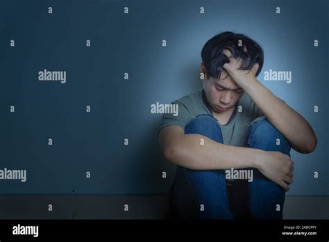 Sad Man Hug His Knee And Cry Sitting Alone In A Dark Room Depression