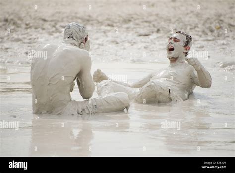 People Enjoy Hot Weather And Bathe In The Mud Pool With Kaolin In