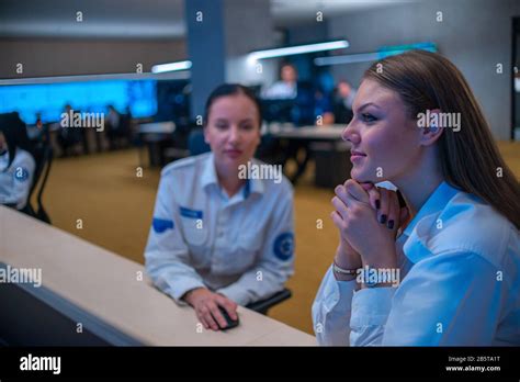 Close Up Photo Of A Security Female Agent Monitoring The CCTV In A Main Data Center Office Stock