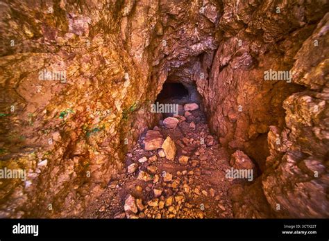 Abandoned Mine Entrance With Rocky Tunnel And Mineral Crystals In