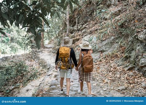 Happy Lgbt Lesbian Couple Travelers Hiking With Backpacks In Forest