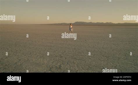 The Girl Walks In The El Mirage Lake Desert Aerial Drone 4k Slow