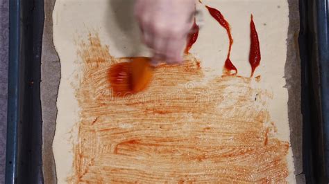 Pizza Dough Is Greased With Tomato Paste Using A Silicone Brush Stock