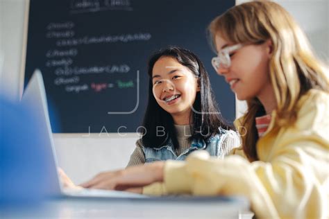 Happy Young Girls Sitting In A Coding Class Learning Basic Programmin Jacob Lund Photography