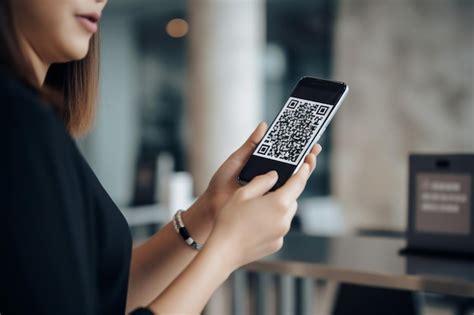 Premium Photo Woman Scanning Qr Code To Pay Bills