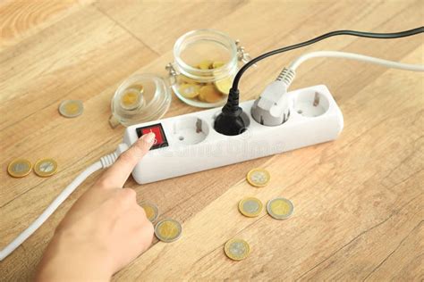Woman Pressing A Power Button Of Extension Cord Indoors Electricity Saving Concept Stock Image