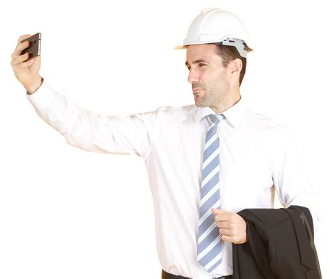 Handsome Smart Engineer Or Architecture Is Wearing A White Safety Hat With Hand Holding