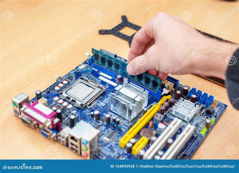 Installing Ddr Memory On Motherboard Hand Pushes The Module Into The Slot Provided On The