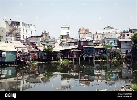 Old Houses On Stilts In The Slums Of Saigon Along A River Full Of Trash Poor Residential Area