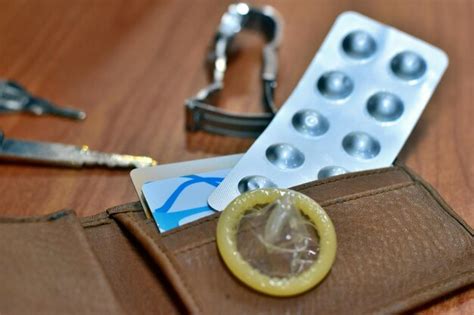 Premium Photo High Angle View Of Condom And Purse With Blister Pack
