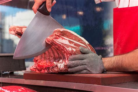 Butcher Cutting Raw Meat By Stocksy Contributor Luis Cerdeira Stocksy