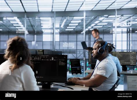 African American Man In Data Center Coordinating Deployment Of Server Architecture Improving