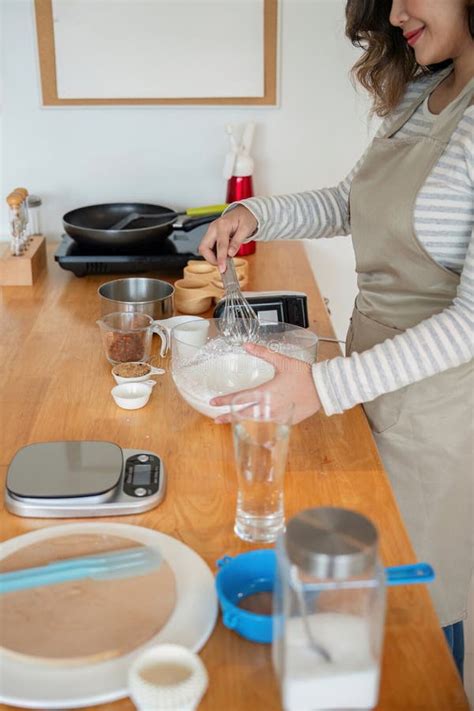 Asian Woman Confidently Whipping Up Batter In Modern Kitchen Stock Image Image Of Home Woman