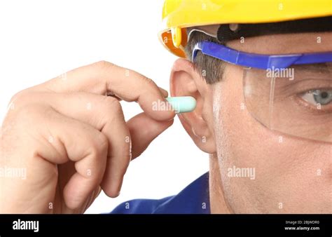 Male Worker With Ear Plug Closeup Health And Safety At Workplace