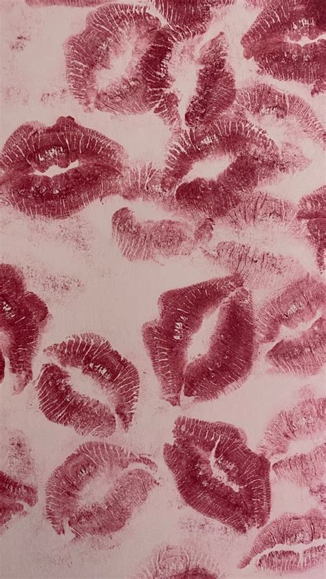 Red Lipstick Imprints On White Paper With Watermarked Lips In The