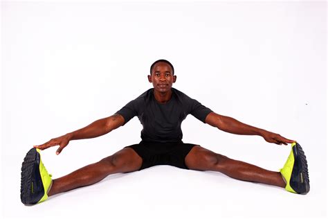 Fitness Man Stretching Legs And Hamstrings Touching Toes High Quality Free Stock Images