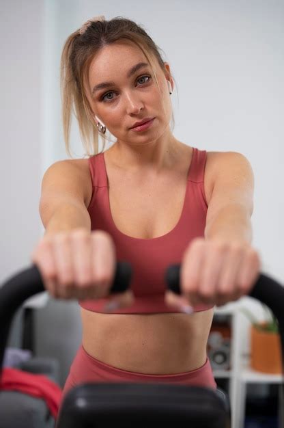 Free Photo Front View Fit Woman On Exercise Bike