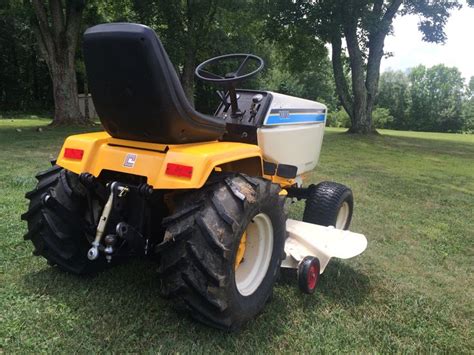 Yellow Cub Cadet Tractor On Lush Green Field