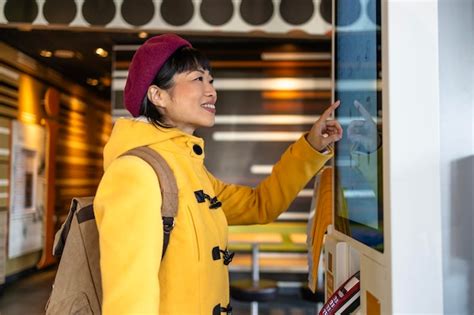 Premium Photo Woman Ordering Meal On Self Service Interactive Display Inside Fast Food Restaurant
