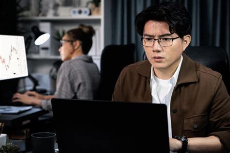 Premium Photo Businessman Focusing Laptop With Coworker Analyzing Stock At Back Infobahn