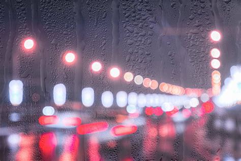 Blurry Lights Of A Car As It Moves Through The City Streets At Night In