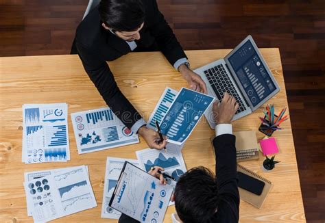 Top View Analyst Team Working On Dashboard Paper On Table Fervent