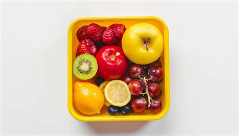 A Fruit In Lunch Box Set On White Background Premium Ai Generated Image