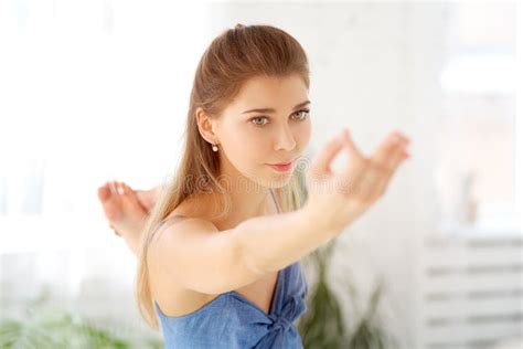 A Beautiful Blonde Girl Stretches Her Hand In Front Of Her