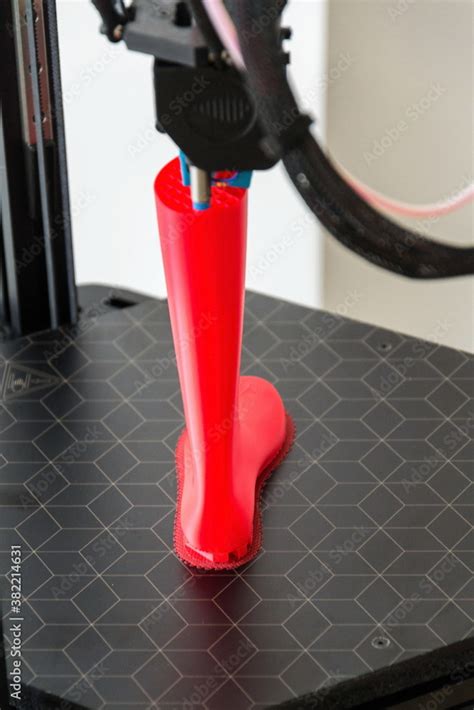3d printer printing plastic last shoe prototype from red filament stock