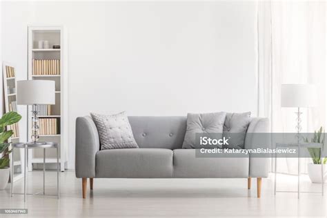 화이트 거실 인테리어 공장에 베개와 함께 회색 소파 옆 실버 테이블에 램프 실제 사진 회색에 대한 스톡 사진 및 기타 이미지