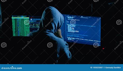Acker In Hood Cracking Code Using Laptop And Computers From His Dark Hacker Room Stock Video