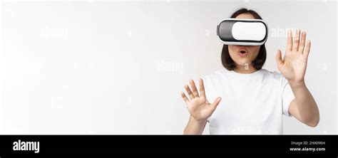Amused Asian Girl Using Vr Glasses Virtual Reality Headset And
