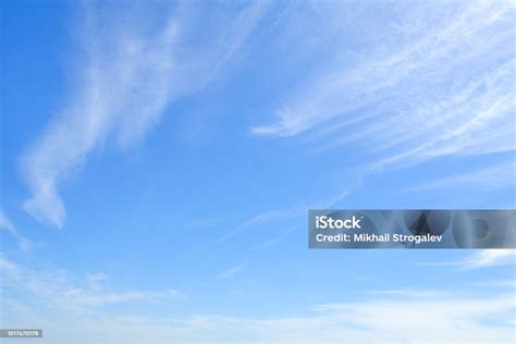White Feather Clouds In Bright Azure Sky As Background With Copy Space