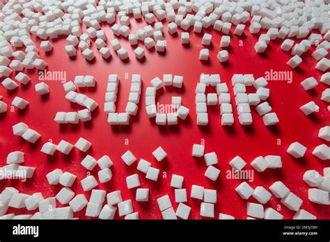 The Word Sugar Is Made Up Of Sugar Cubes On A Red Background Photo On The Topic Of The Dangers