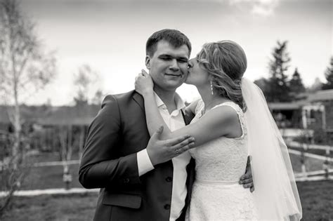 Premium Photo Closeup Black And White Portrait Of Bride Giving A Kiss On Grooms Cheek