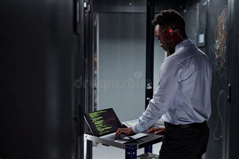 Network Engineer Using Laptop While Setting Up Servers In Data Center Stock Image Image Of