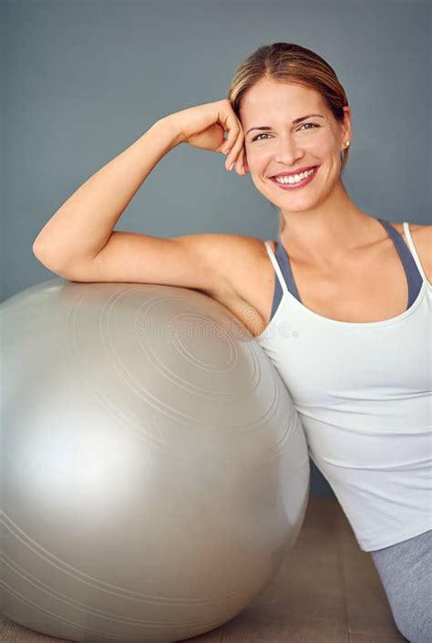 Have A Ball A Sporty Young Woman Sitting Next To Her Fitness Ball