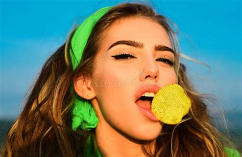 Girl Eating Chips Holding In Mouth Hungry Female Face Closeup Stock Image Image Of Look