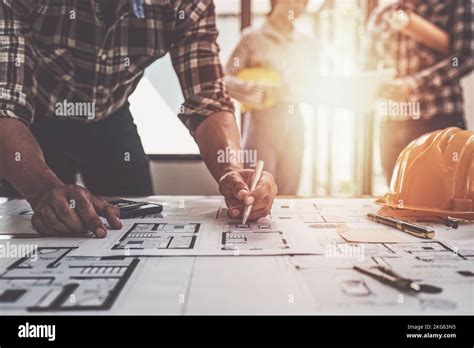 Professional Architect Designer Structural Engineer Team Colleagues Discussing Building Plan