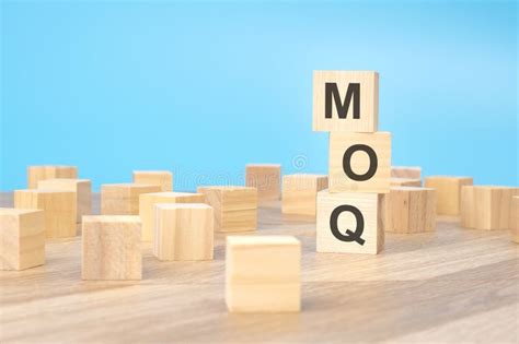 Moq Short For Minimum Order Quantity Written On A Wooden Cube Business Concept Blue