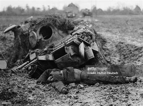 A Dead German Soldier Lies Alongside His Destroyed Tank After Heavy