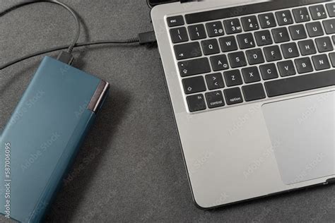 Laptop Is Charged By Powerbank Top View Laptop Is Connected By Cord To An External Battery